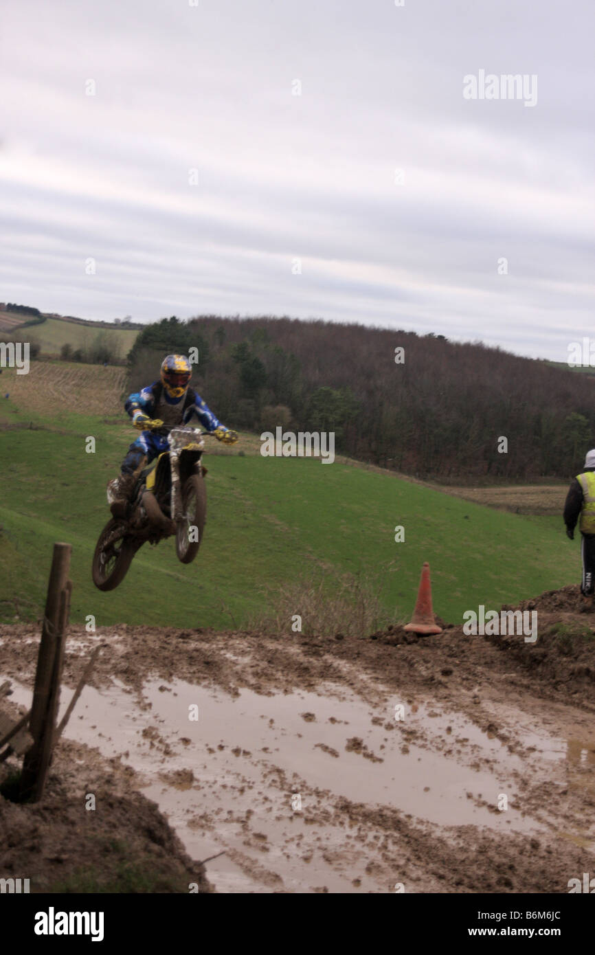 Motocross rider performing jump at dirt track Stock Photo - Alamy