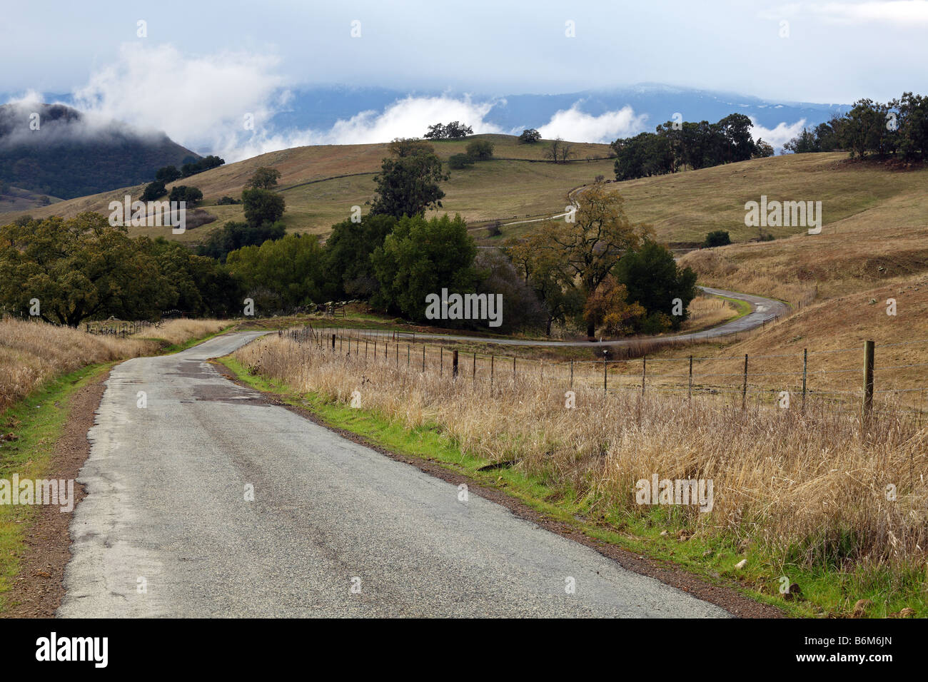 A rural road winding on Stock Photo - Alamy