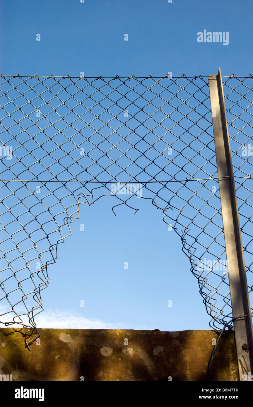Hole in a security net Stock Photo - Alamy