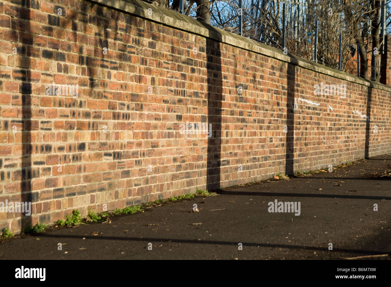 Path with brick wall Stock Photo - Alamy