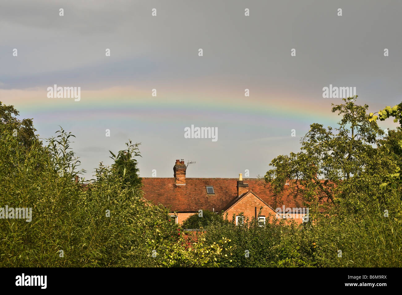 Suburban roof top crowned with a rainbow Stock Photo - Alamy