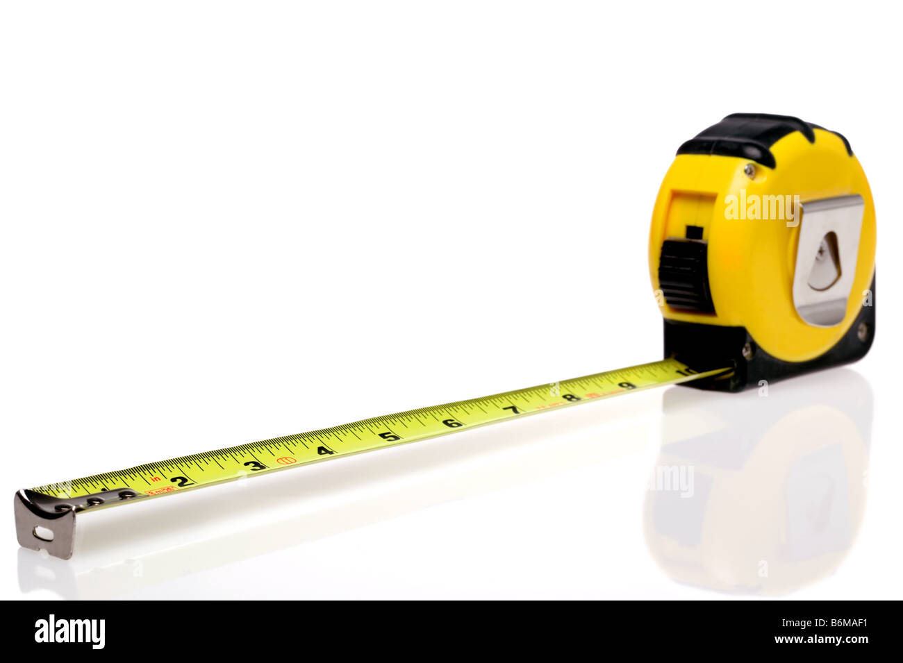 A yellow retractable steel tape measure isolated on a white background ...