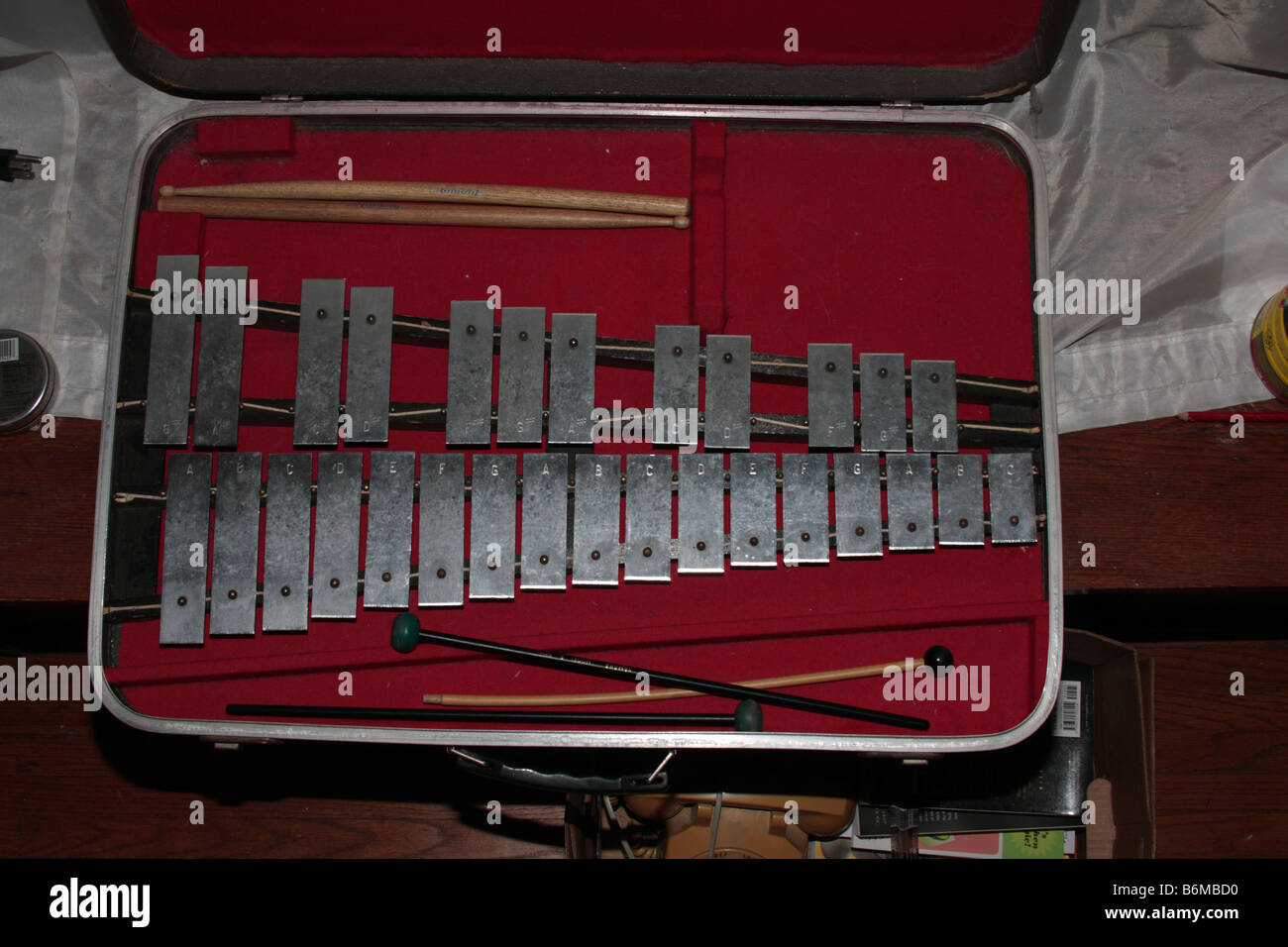 Dusty steel xylophone bells inside red felt-lined case Stock Photo - Alamy