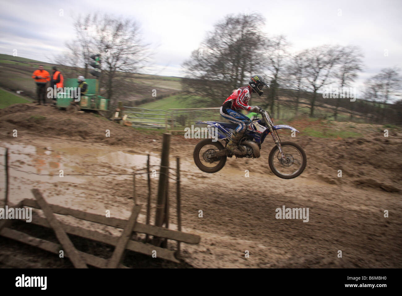 Motocross rider performing jump at dirt track Stock Photo - Alamy
