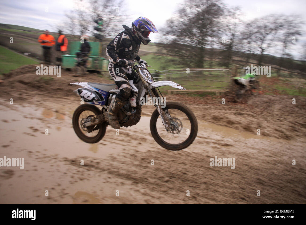 Motocross rider performing jump at dirt track Stock Photo - Alamy