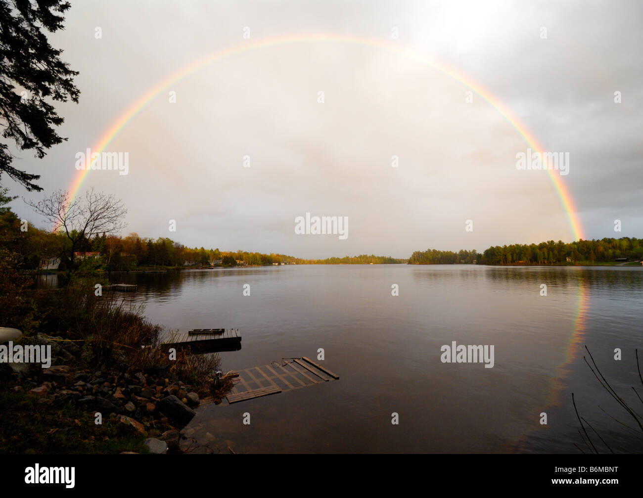 full rainbow over the water Stock Photo - Alamy