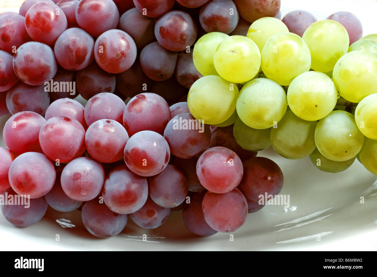 Red and white grapes on white background Stock Photo - Alamy