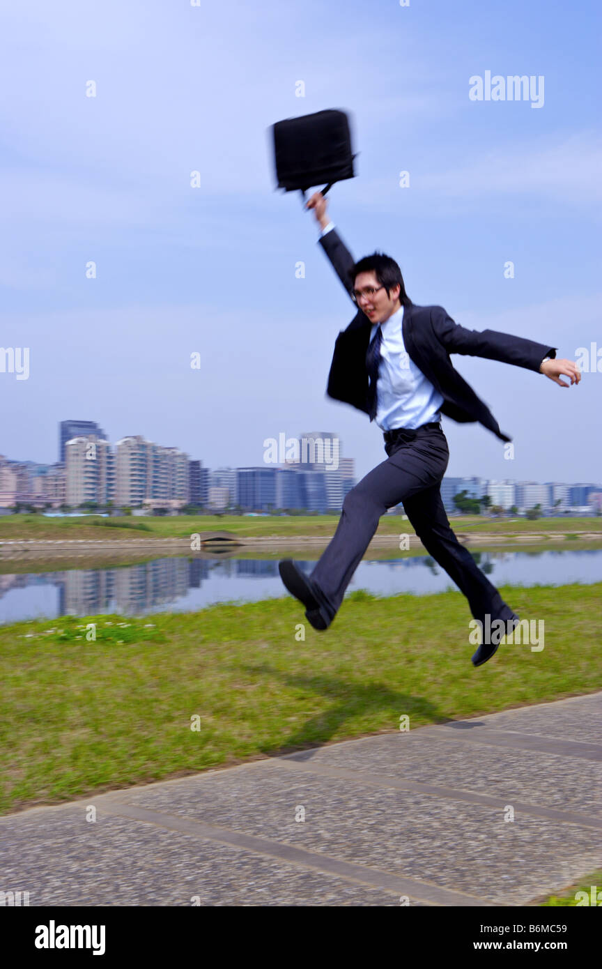 Asian businessman running holding hi-res stock photography and images ...