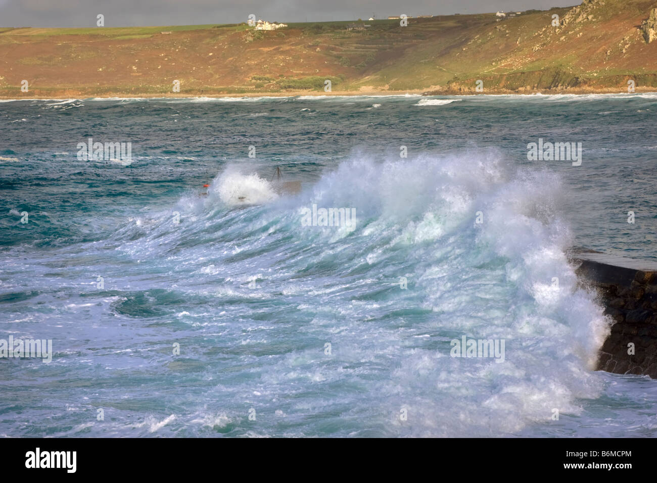 Waves crash over the breakwater at Sennen Cove Cornwall Stock Photo - Alamy