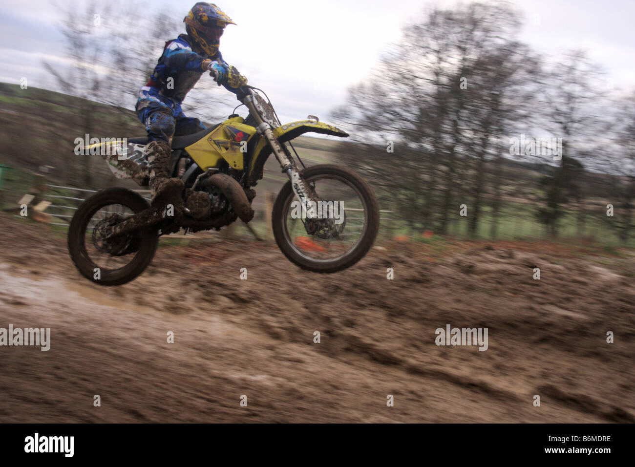 Motocross rider performing jump at dirt track Stock Photo - Alamy