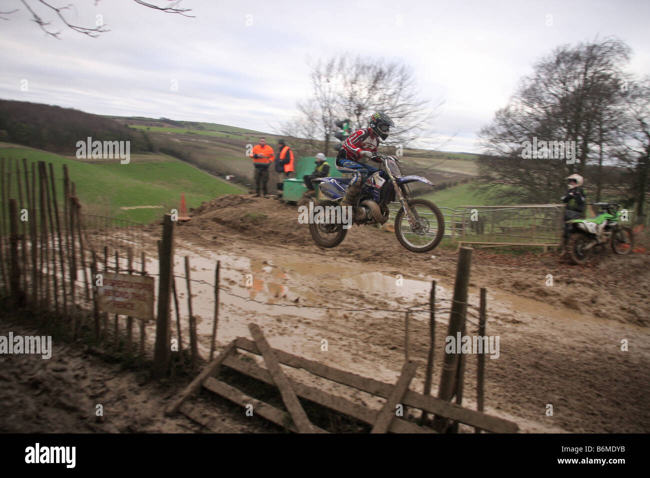 Motocross rider performing jump at dirt track Stock Photo - Alamy