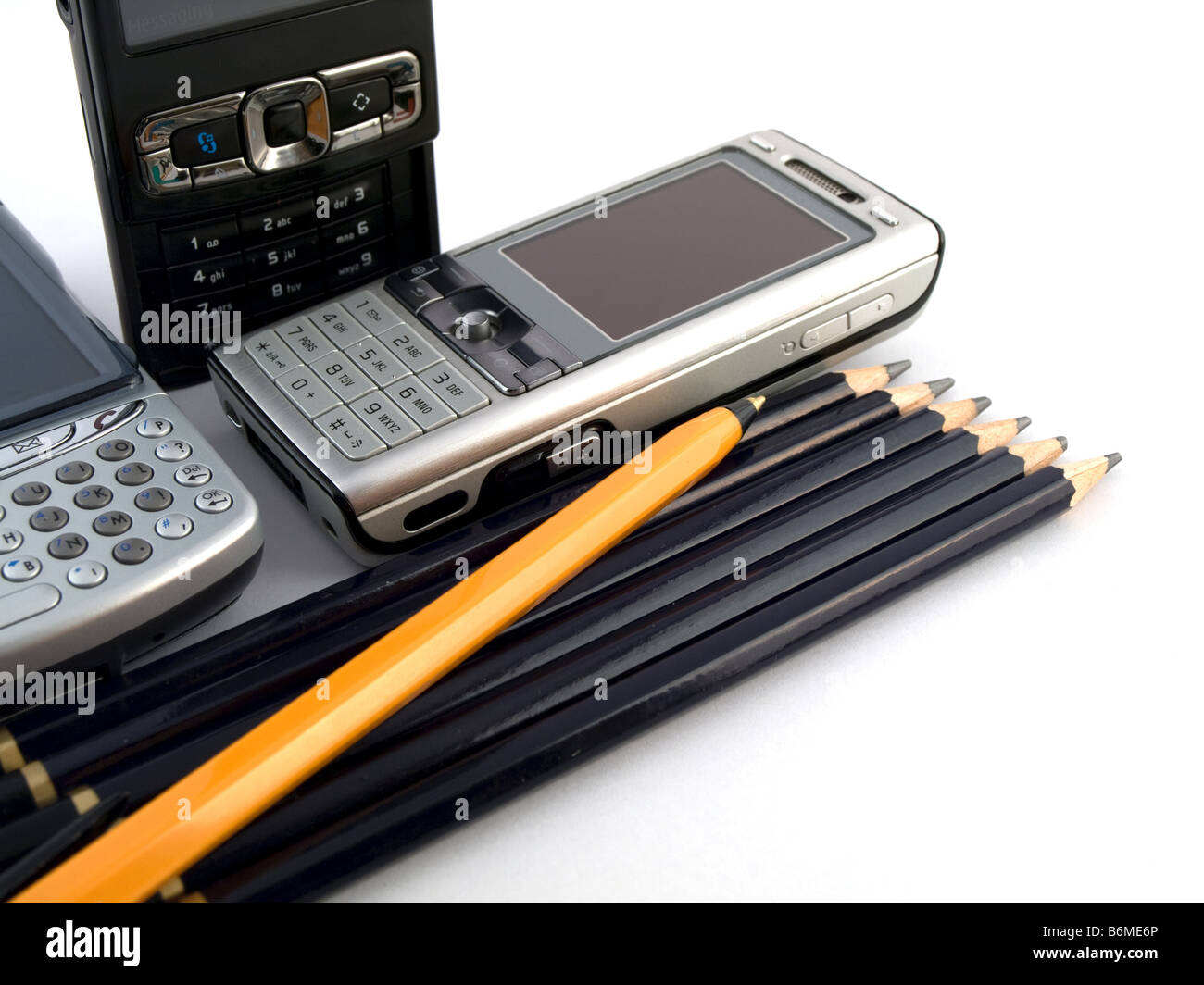 Modern Mobile Phones Pens and Pencils on White Background Stock Photo ...