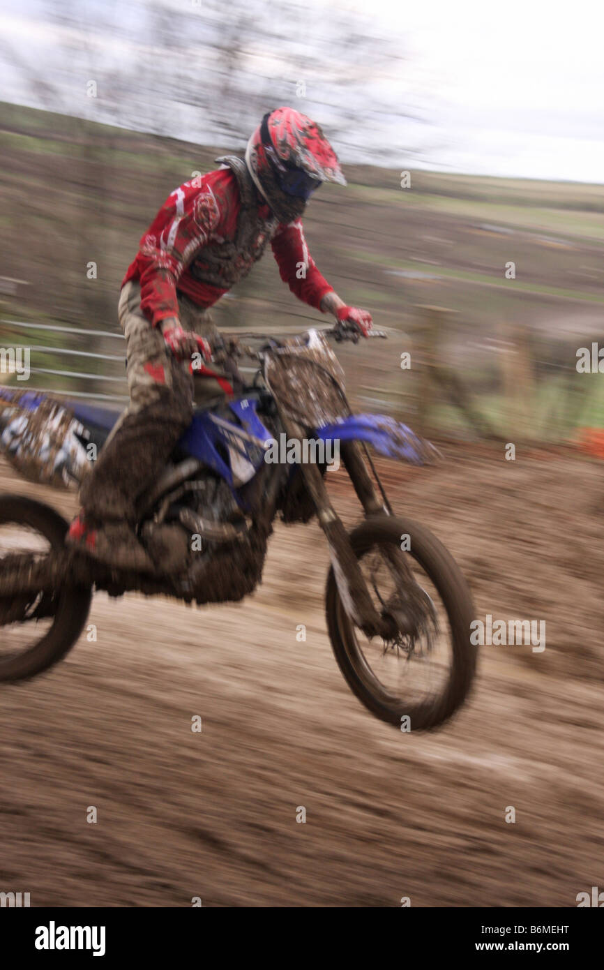 Motocross rider performing jump at dirt track Stock Photo - Alamy