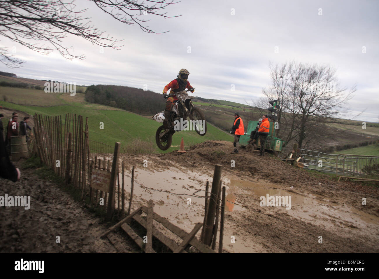 Motocross rider performing jump at dirt track Stock Photo - Alamy