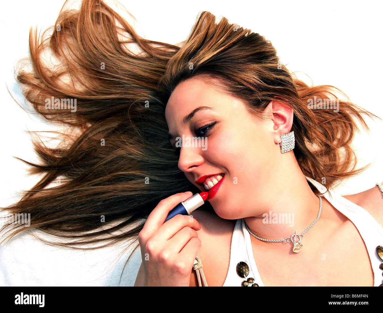 Girl applying lipstick and makeup portrait Stock Photo - Alamy