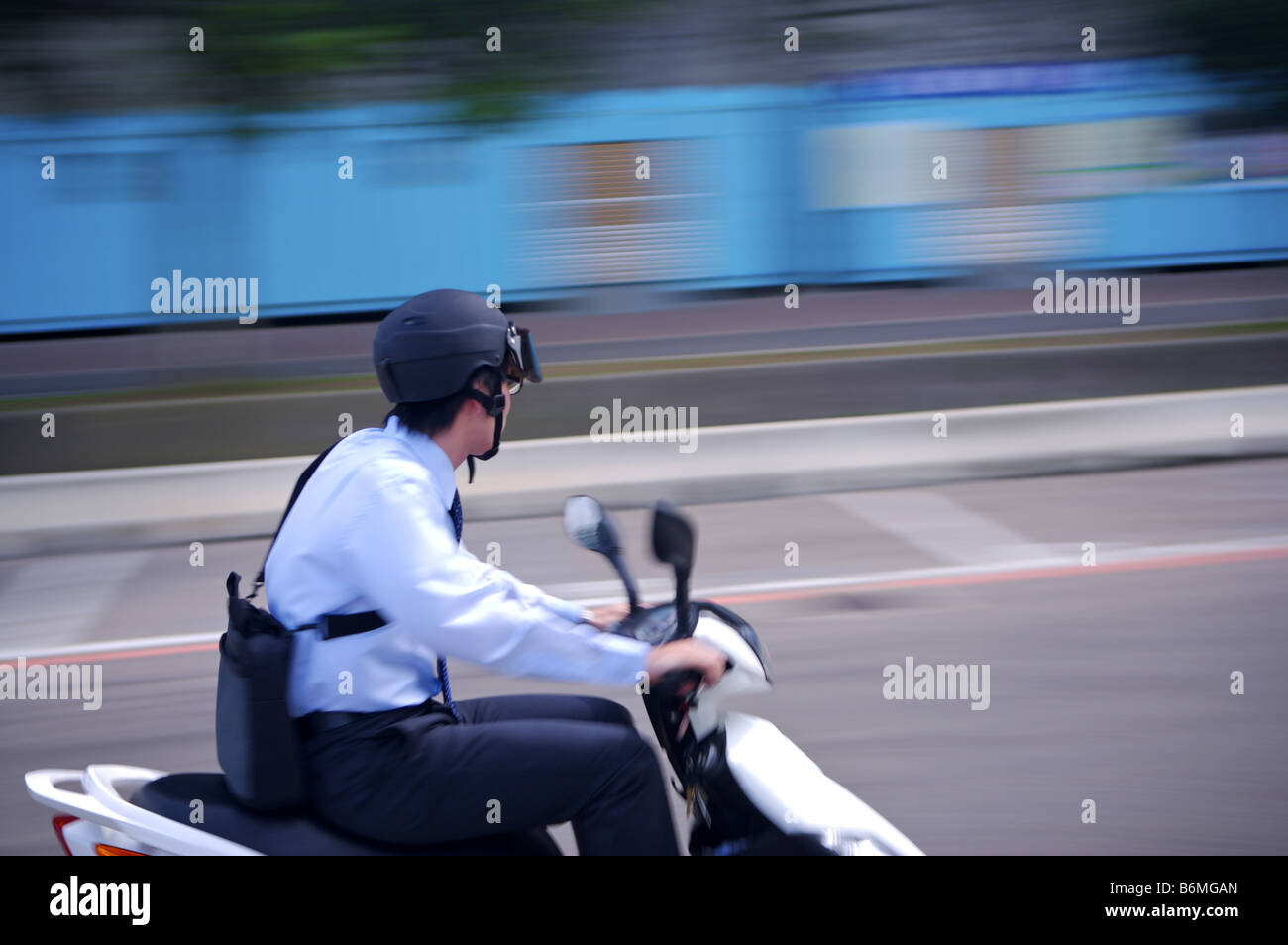 Young businessman riding motorcycle Stock Photo - Alamy