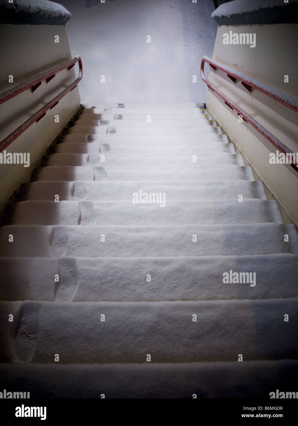 Steps Covered With Snow and Footprints With Red Hand Rail Stock Photo ...