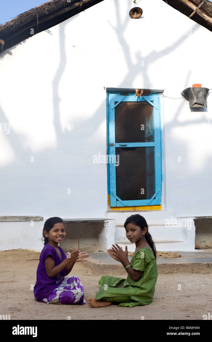 Young Indian village girls playing a hand clapping game outside a rural ...
