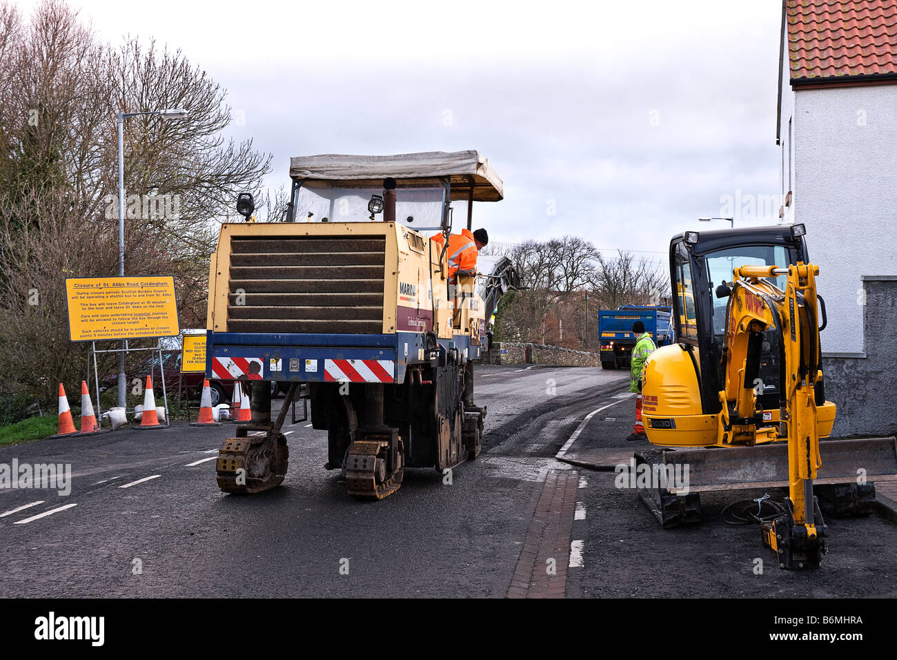 A planer manoeuvring into position to remove tarmac from the road ...