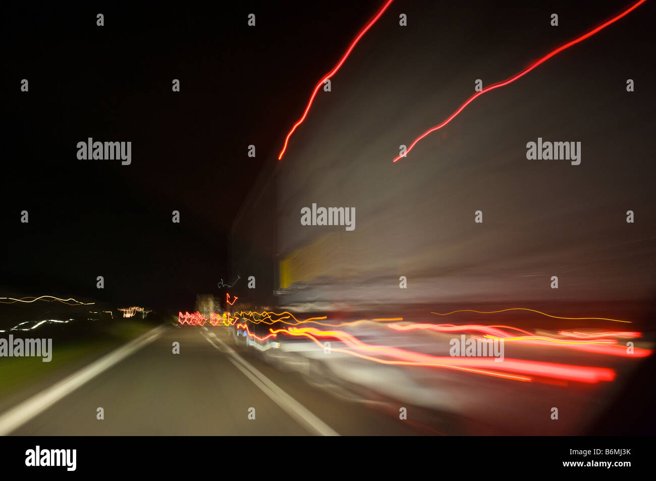 Passing a lorry on the German autobahn in a car at night, blurred view ...