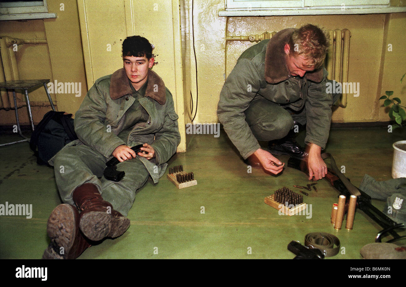 Polish border guard officers preparing a rifle for a night patrol ...