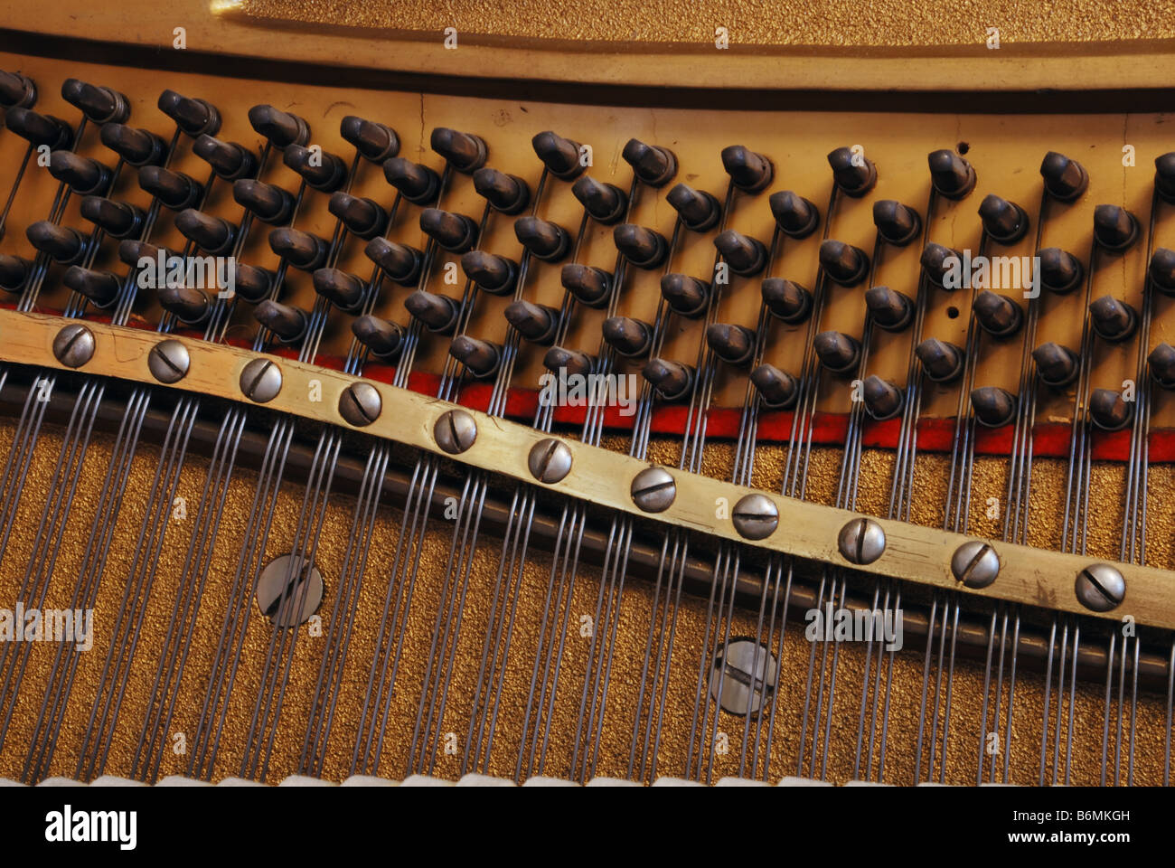 inside the piano strings and pins close up Stock Photo - Alamy