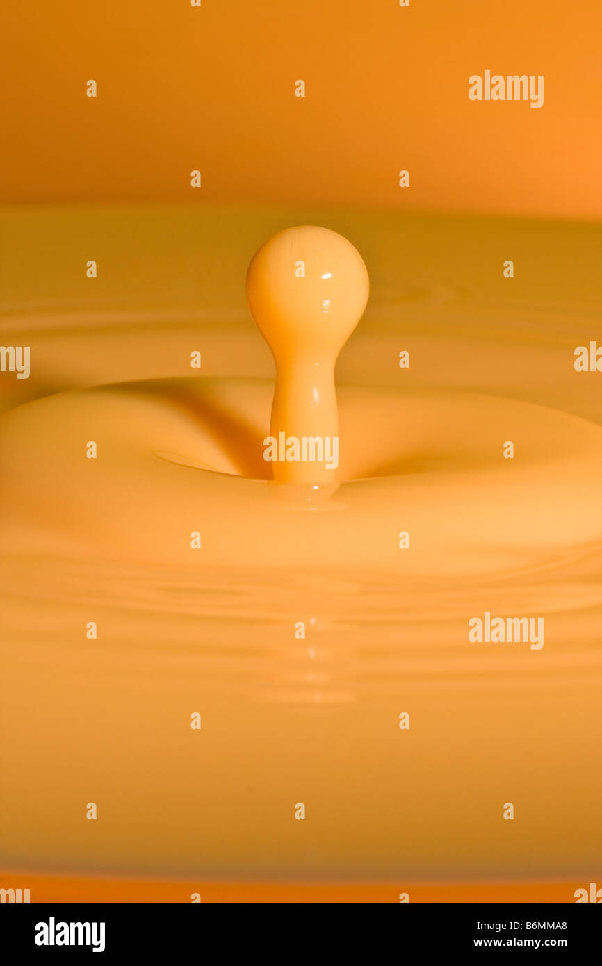 Pastel yellow colored milk droplet splashing up Stock Photo - Alamy
