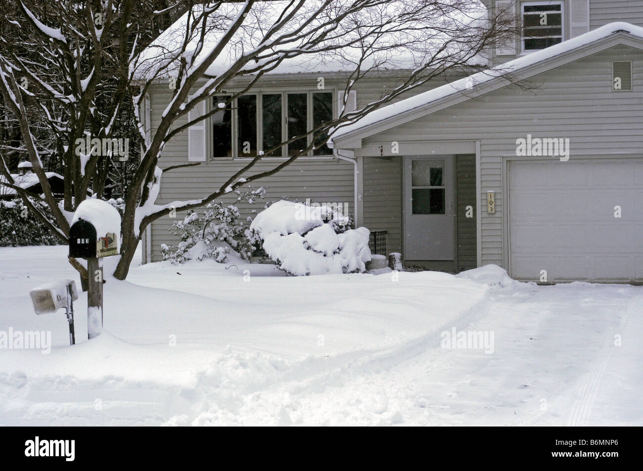 Neighborhood house after a snow storm Stock Photo - Alamy
