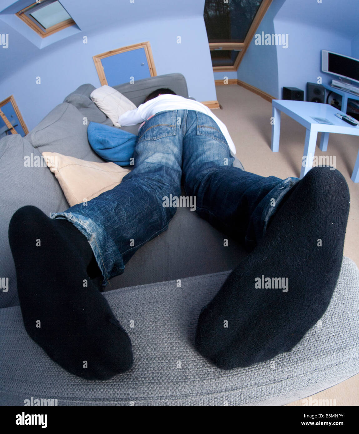 teenage boy sleeping on couch Stock Photo - Alamy