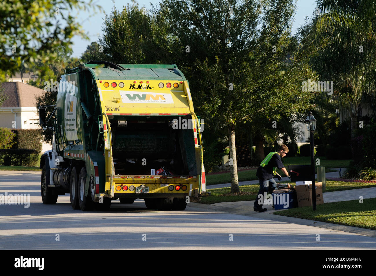 Garbage collection truck and operative Florida USA Stock Photo - Alamy