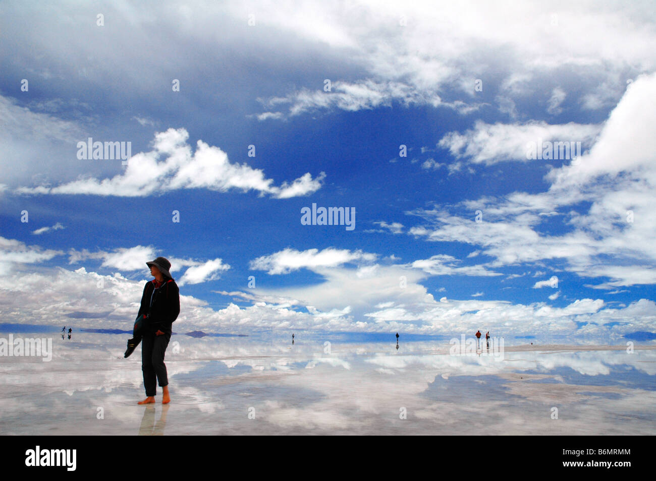 People walking over the water Uyuni Bolivia Stock Photo - Alamy