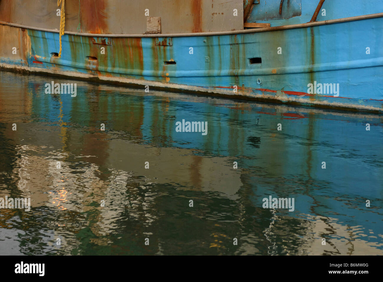 Old rusty iron boat and its reflection in the water Stock Photo - Alamy