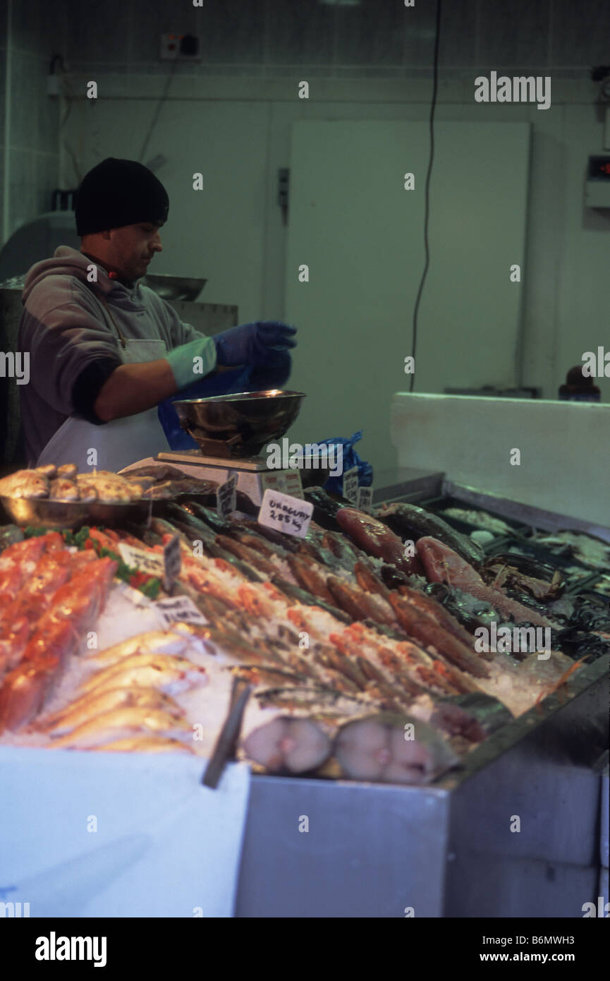 Fishmonger and display on market stall Stock Photo - Alamy