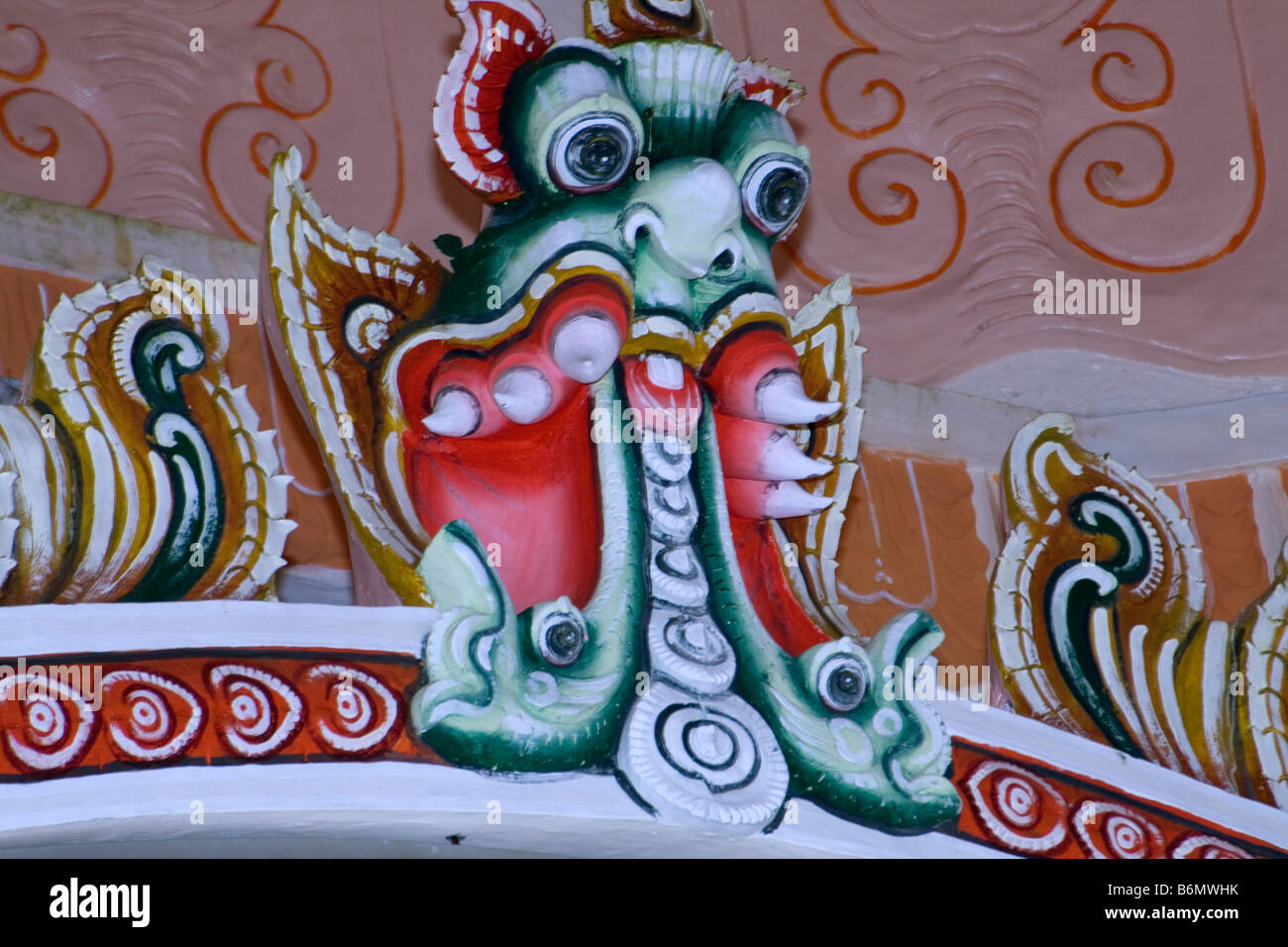 Bright painted detail of demon surrounding a shrine at the sacred site ...
