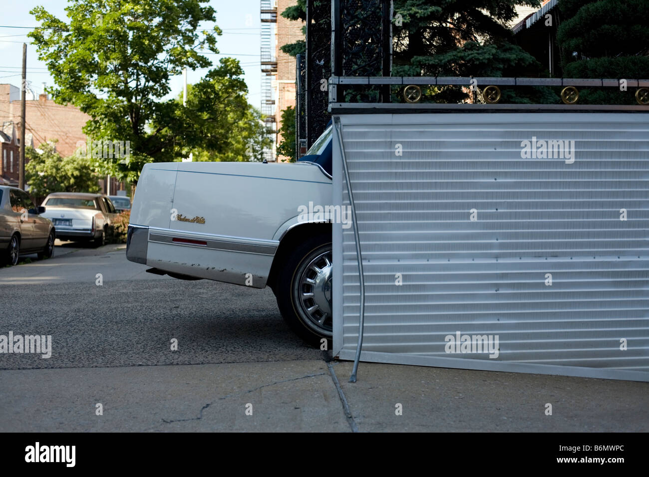 a big cadillac parked in a driveway, blocking sidewalk Stock Photo - Alamy