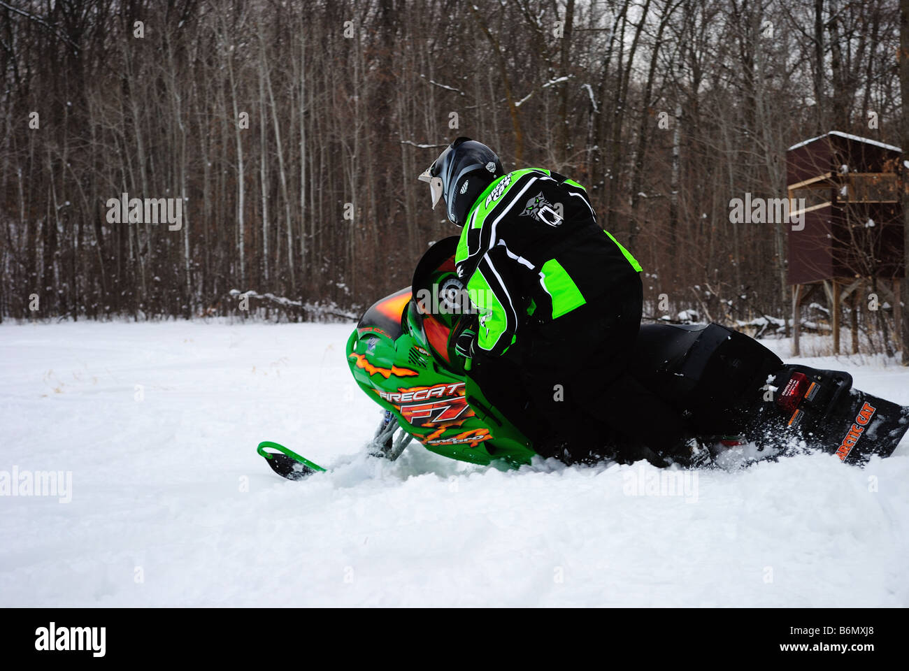 Snowmobiler turning sharply Stock Photo - Alamy