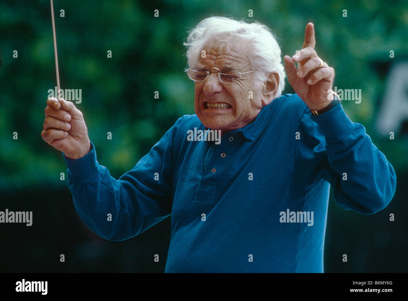 Leonard Bernstein, his face contorted with pain through discordant note ...