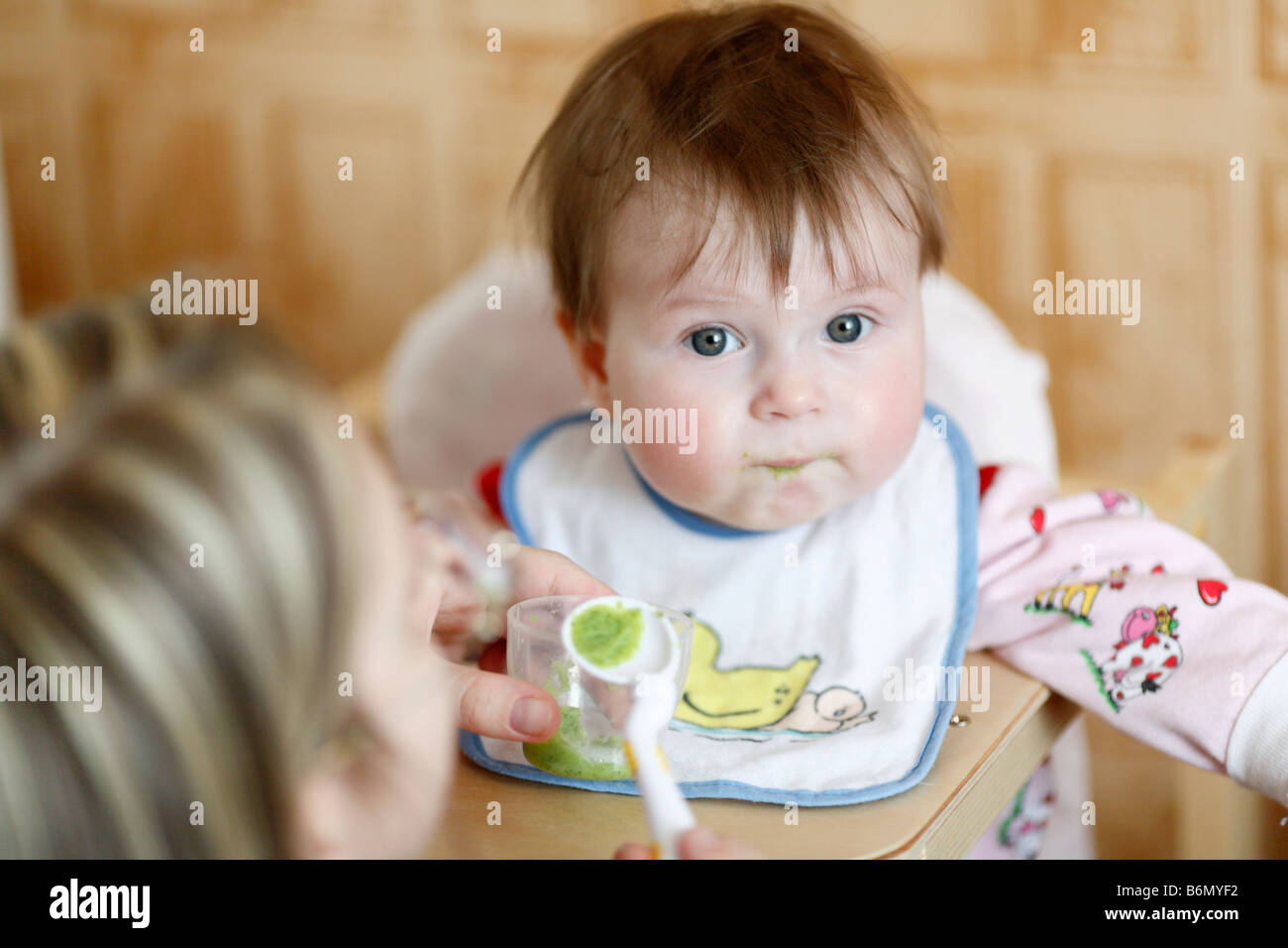 Baby girl eating Stock Photo - Alamy