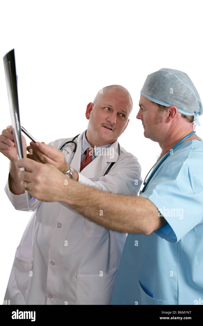 Two doctors consulting on an xray prior to surgery Stock Photo - Alamy