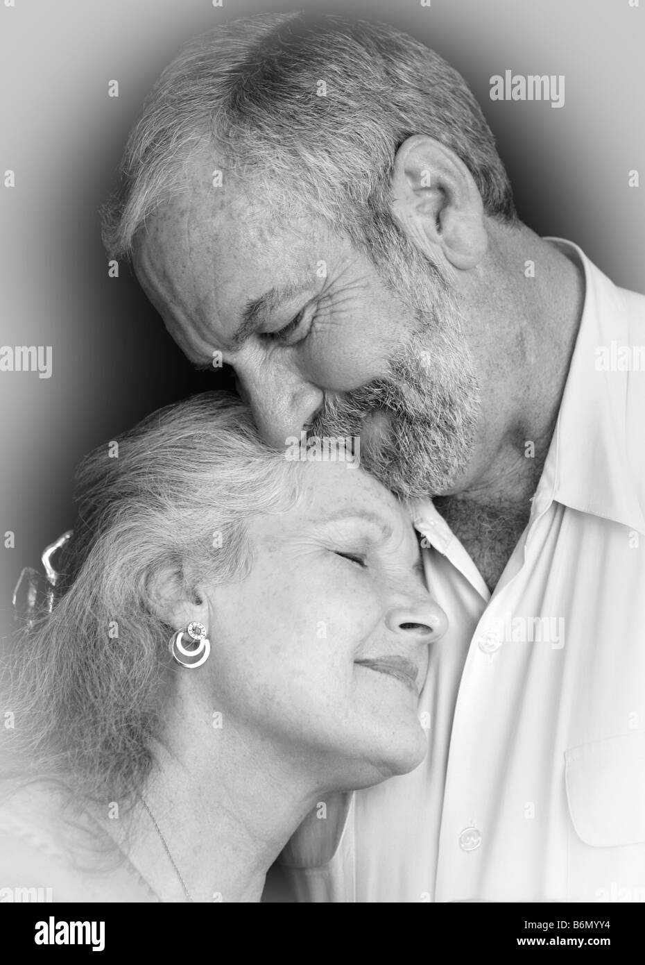 A beautiful middle aged couple tenderly embracing eachother They are ...