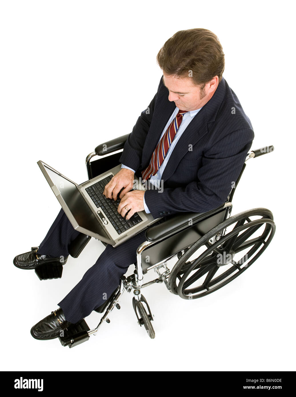 Businessman in a wheelchair working on his laptop computer Full Body ...