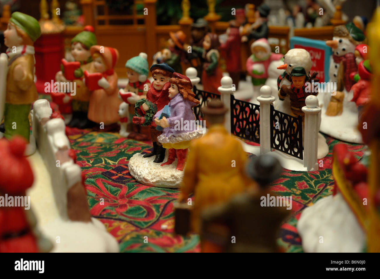 Close-up of miniature ceramic people figurines in a Christmas holiday ...