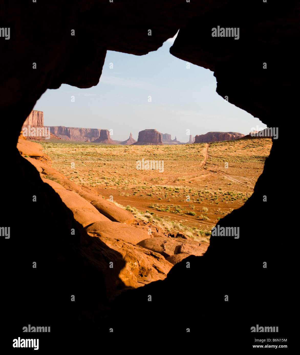 A view of Monument Valley seen through a rock window Stock Photo - Alamy
