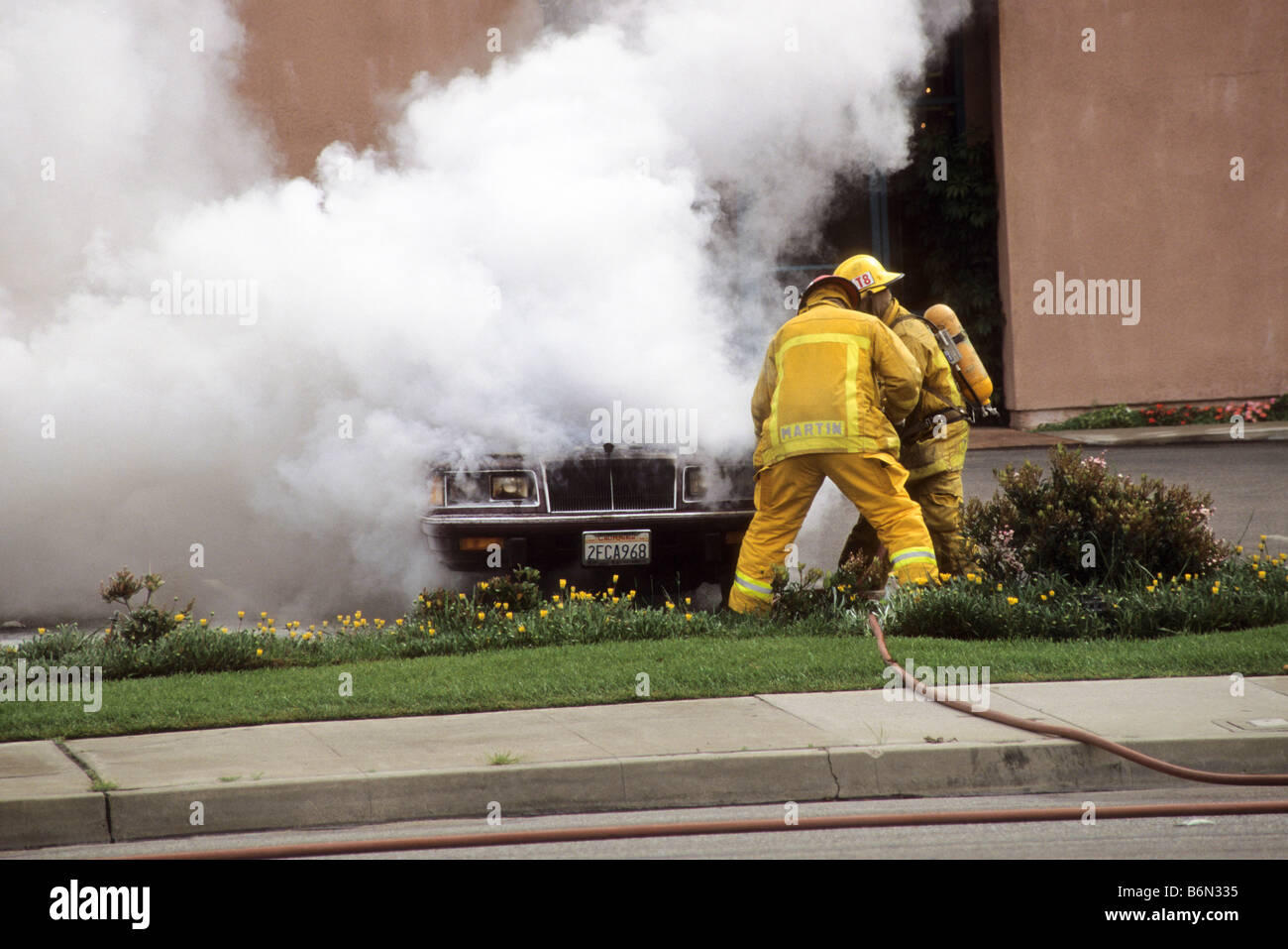 Car on fire with smoke pouring from under the hood Stock Photo - Alamy