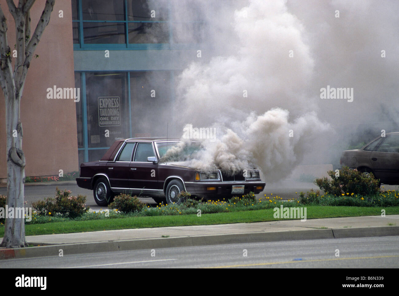 Car on fire with smoke pouring from under the hood Stock Photo - Alamy