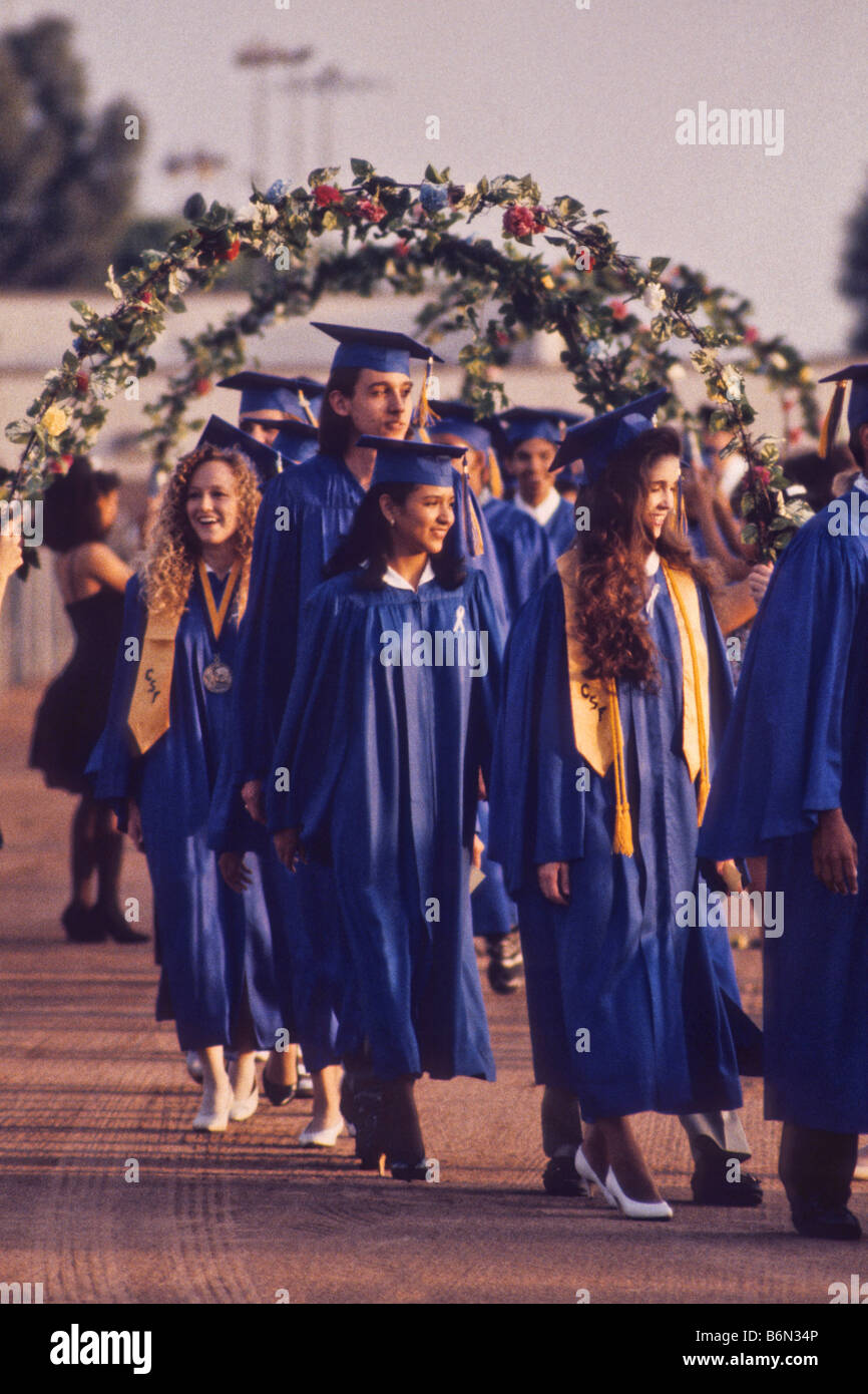 High school graduates march into ceremony in outdoor event Stock Photo ...