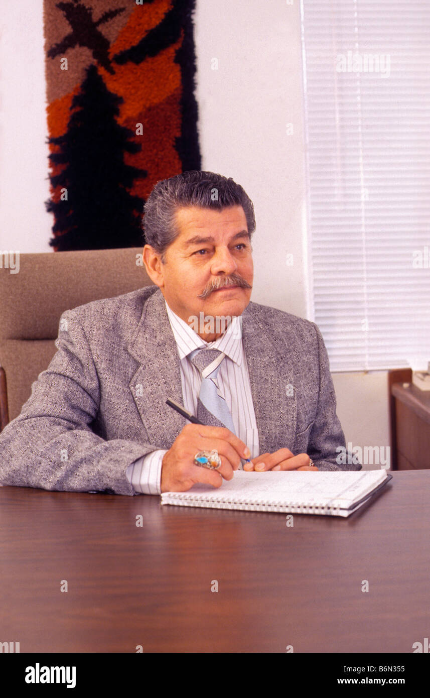 Male Hispanic executive works at office desk Stock Photo - Alamy