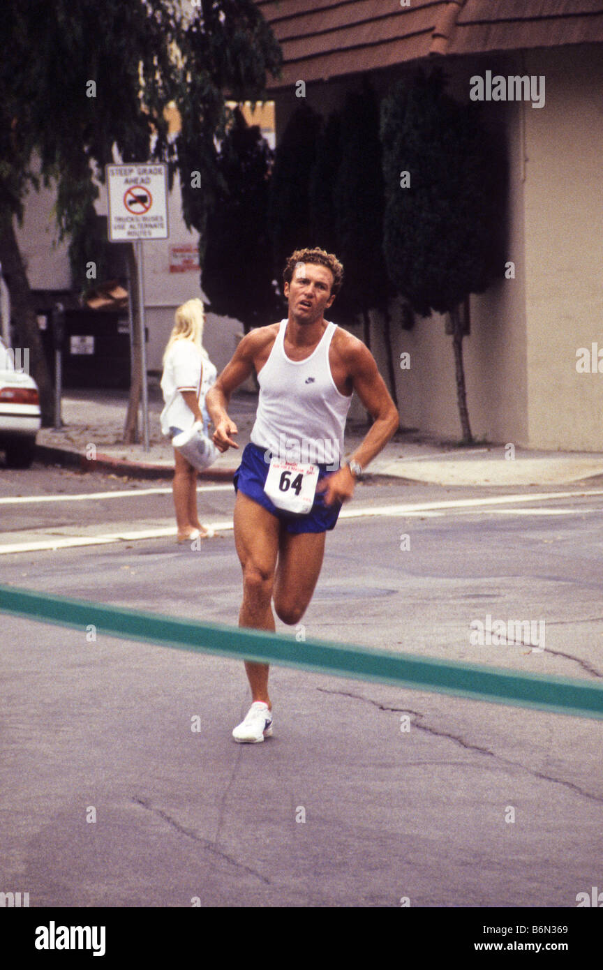 Lone marathon runner makes turn toward end of race Stock Photo - Alamy