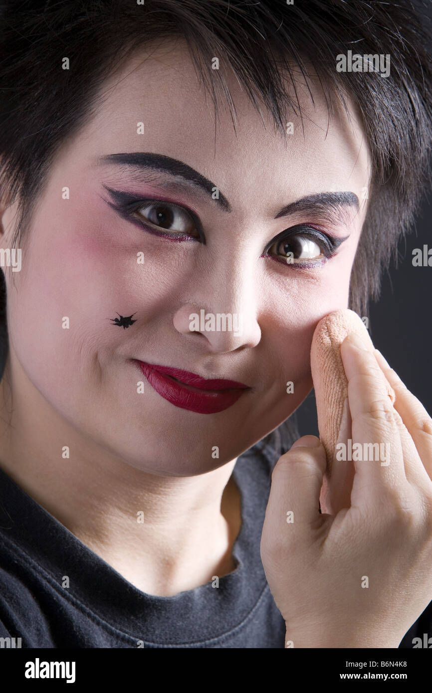 Female opera performer using powder puff Stock Photo - Alamy