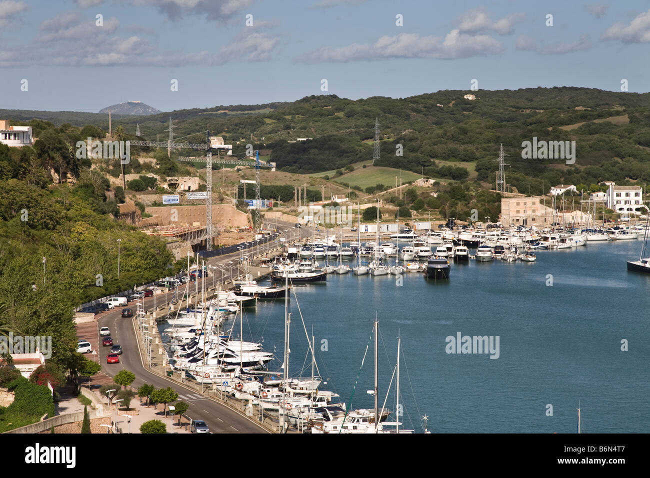 The marina at Mao port in Menorca, Spain with Monte El Toro in the ...